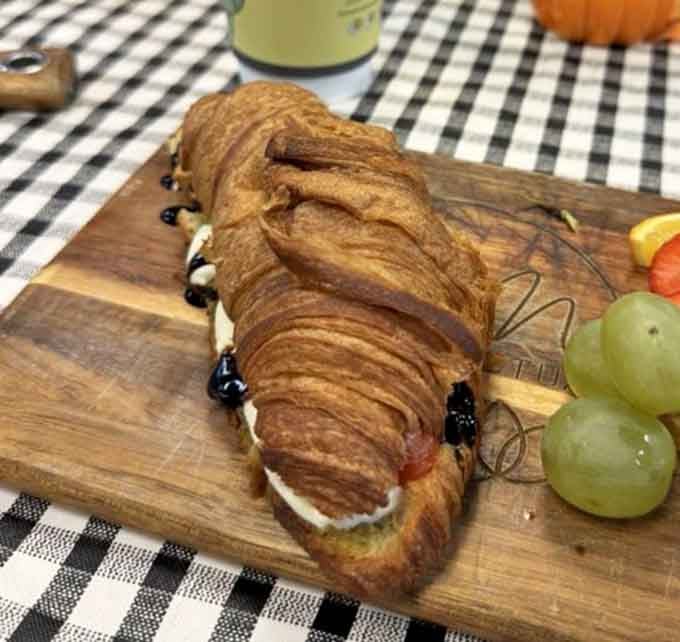 A croissant sandwich that understands the assignment: be flaky, be delicious, and make people forget about their diet plans.