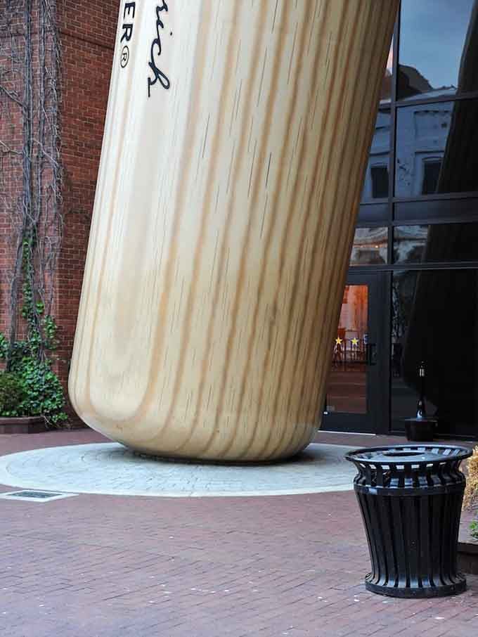 The base of the giant bat next to a regular trash can provides perfect scale, making the can look like a thimble.