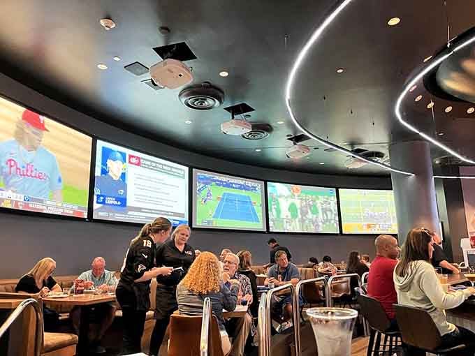 Multiple screens positioned strategically mean every seat offers prime viewing angles, solving the age-old sports bar seating debate once and for all.
