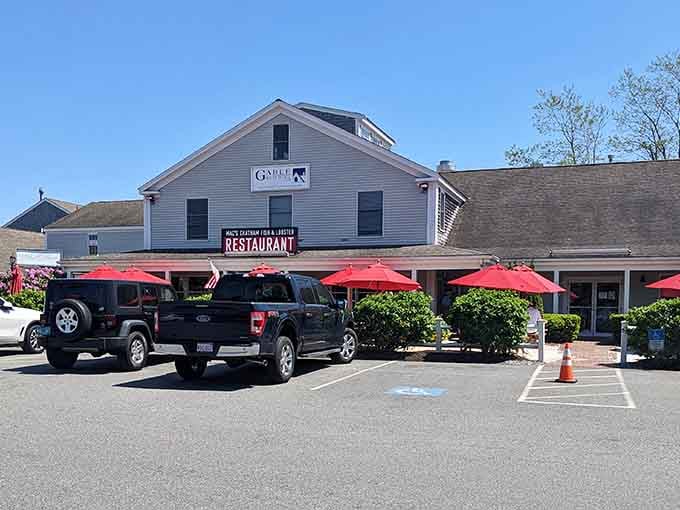 Red umbrellas signal outdoor dining paradise ahead, like beacons guiding hungry travelers to their happy place.