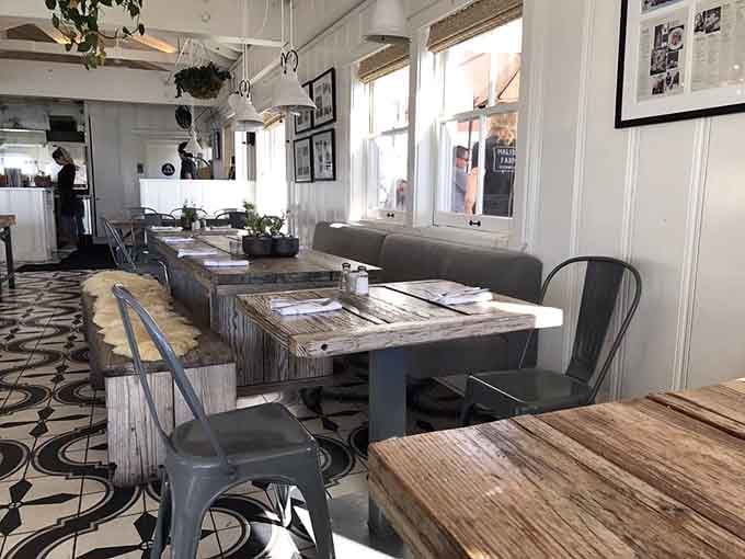 Weathered wood tables on the outdoor deck put you practically over the water for ultimate seaside dining.