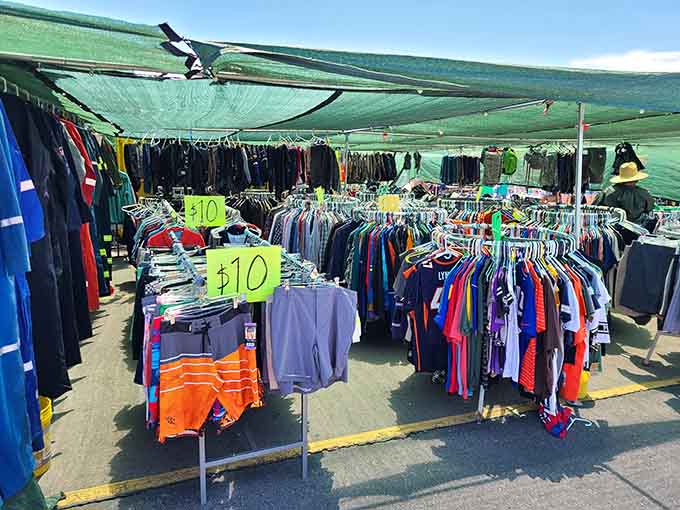 Clothing racks stretching endlessly under shade canopies, offering bargains that make retail prices seem ridiculous.