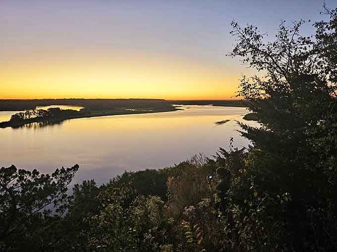 Sunset paints the Mississippi in liquid gold, reminding us why some moments are worth putting down the phone.