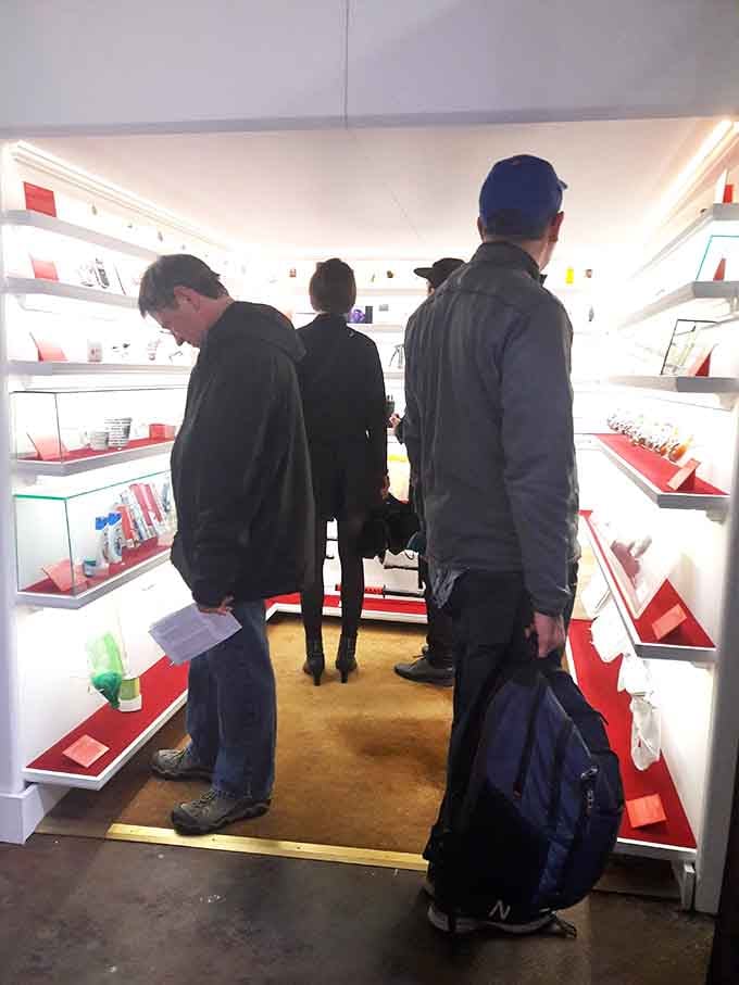 Three people squeeze into a space smaller than most closets, united in their fascination with the wonderfully mundane.