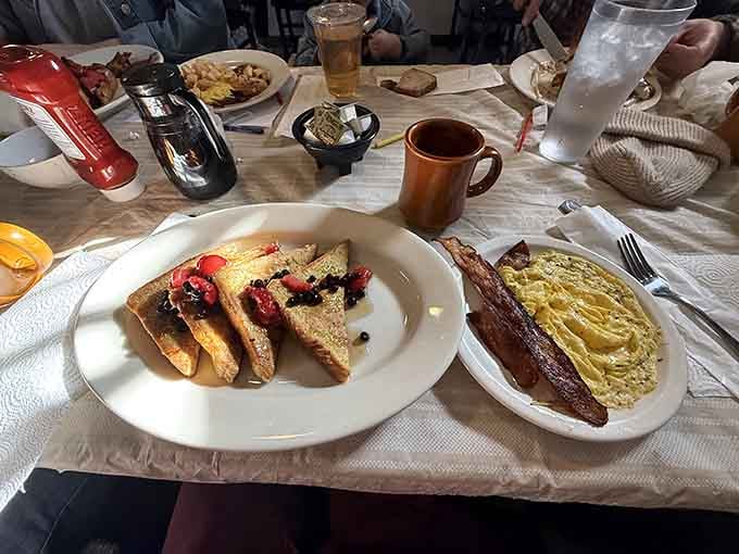 French toast with berries and bacon proves that breakfast here takes the sweet and savory balance seriously.