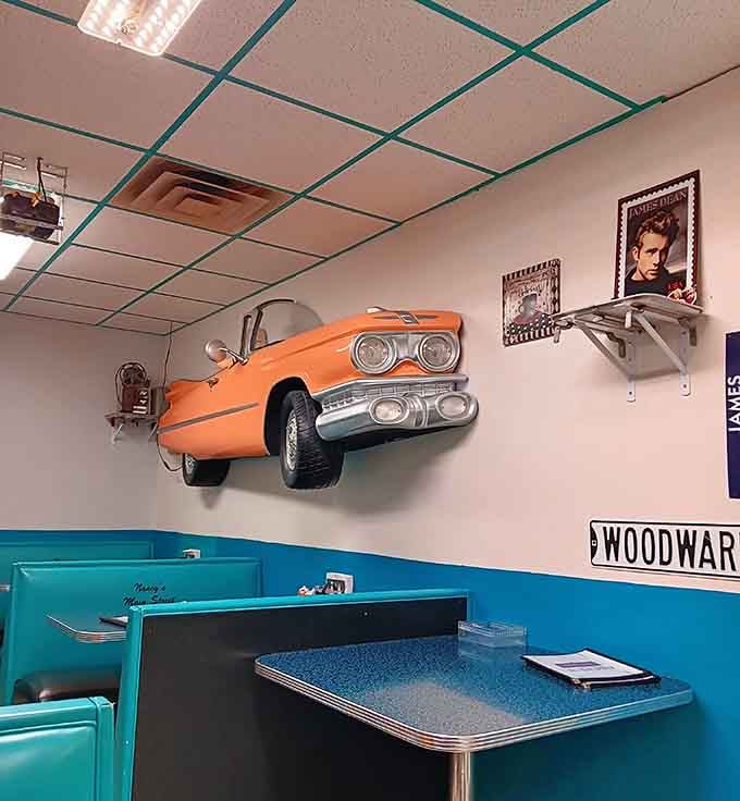 That orange vintage car bursting through the wall adds whimsy to your breakfast experience in the best possible way.