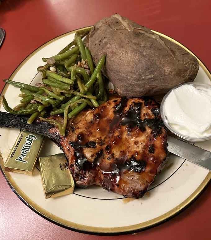 Glazed pork chops with green beans and a baked potato, this is the kind of hearty plate that sticks to your ribs.