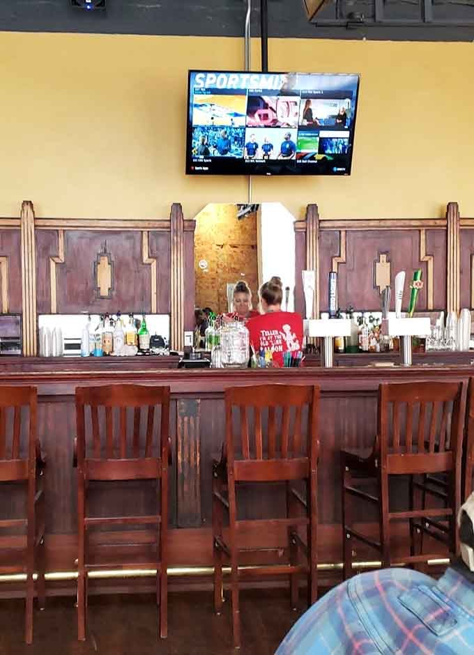 The bar area features wooden stools, flat screens, and everything you need for a proper Texas-style unwinding session.