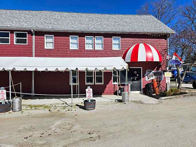 The red-and-white awning beckons like a beacon of hope for anyone seeking good wine and better times.