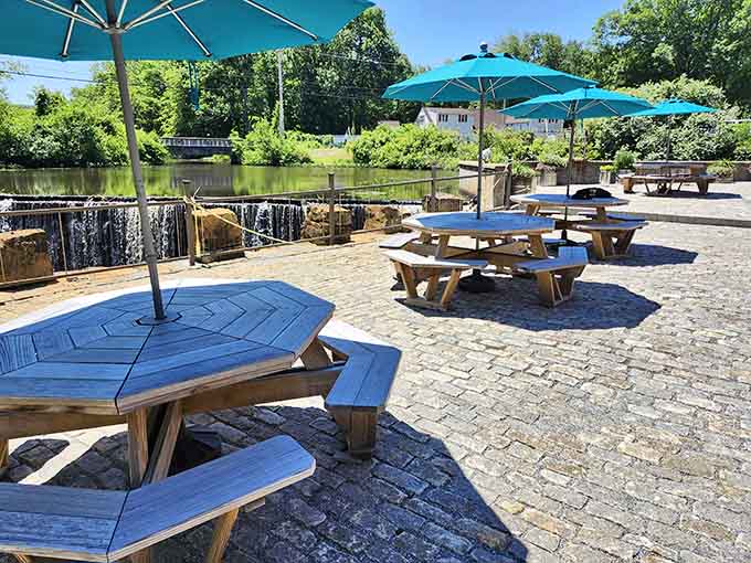 Blue umbrellas and waterfall views create the kind of outdoor dining experience that makes you grateful for warm weather.