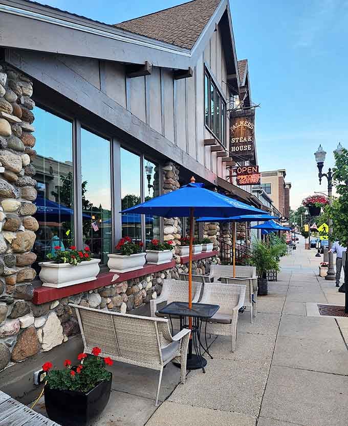 Sidewalk seating under blue umbrellas turns dinner into a Lake Country people-watching adventure with benefits.