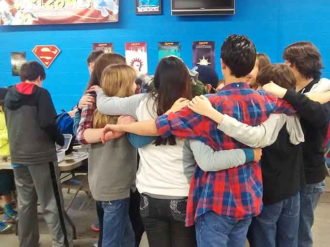 Friends huddle together in genuine camaraderie, proving that the best games create connections that last beyond the table.