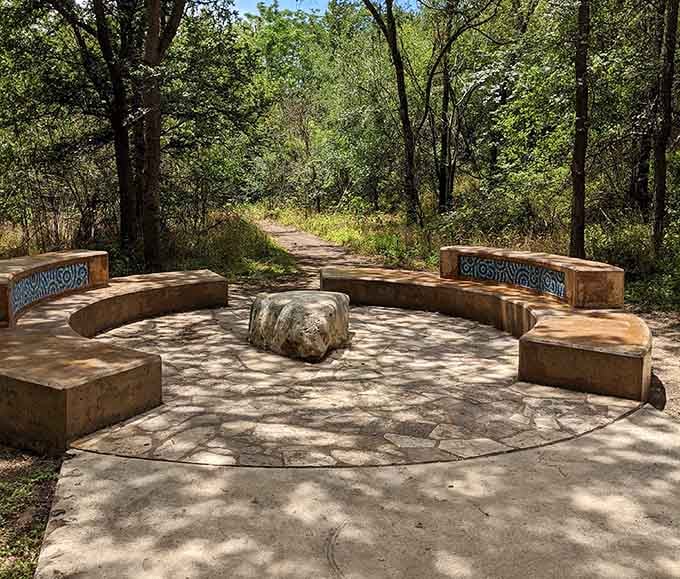 Shaded seating areas with decorative tilework provide peaceful spots for rest between playground adventures.