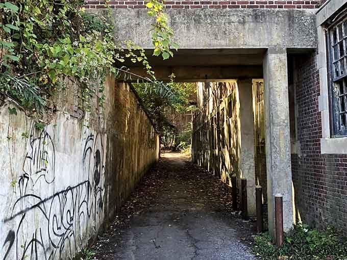 Graffiti-covered tunnels add another layer of decay to passages that already carry enough dark history.