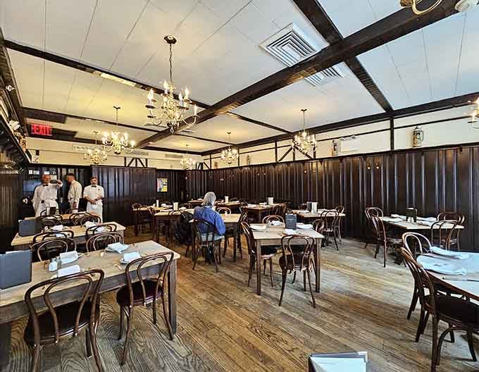 Spacious dining area with bentwood chairs and white tablecloths, elegantly simple and timelessly perfect.