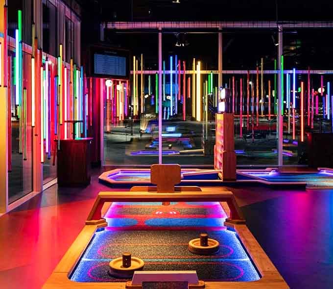 Vertical neon tubes create a futuristic forest where your ball navigates obstacles bathed in electric color.