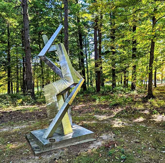 Polished metal ribbons dance through dappled forest light like Fred Astaire decided to become a sculpture.