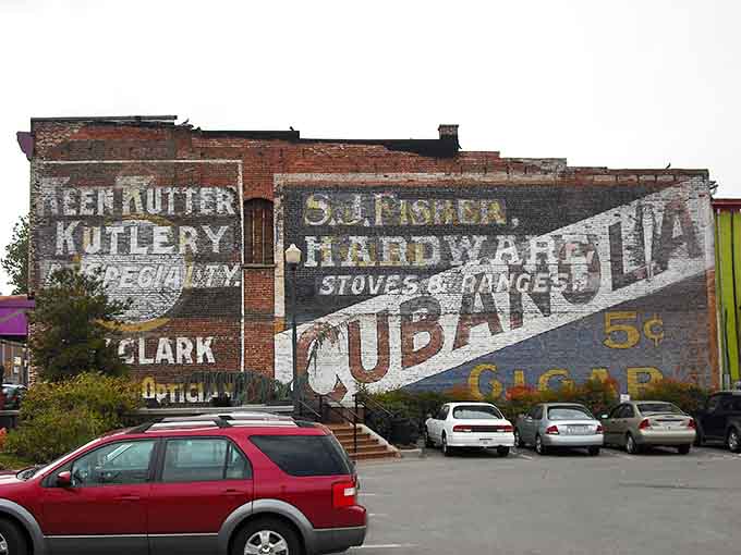 Faded advertisements painted on brick walls whisper about hardware stores and five-cent soap from another lifetime entirely.