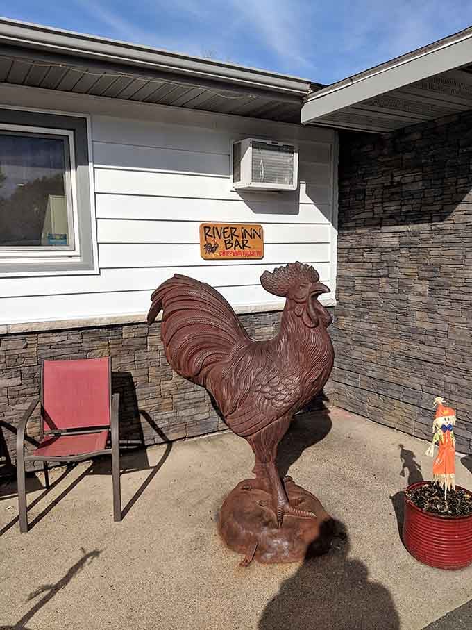 A proud rooster statue stands guard outside, announcing this establishment's commitment to poultry excellence with metal authority.