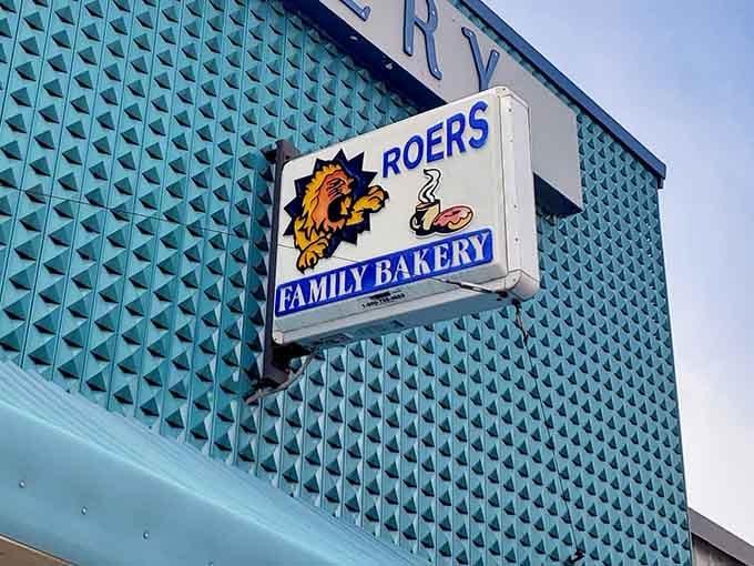 The cheerful lion mascot on the sign looks as happy as customers feel when leaving with bags of treats.