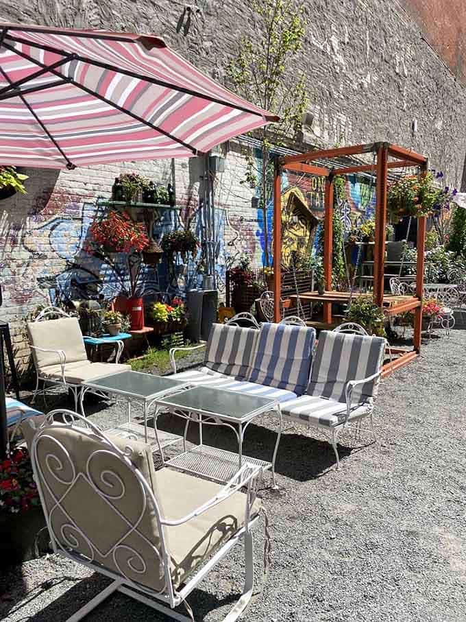 Striped umbrellas and vintage furniture create an outdoor oasis that feels like vacation without the airport hassle.