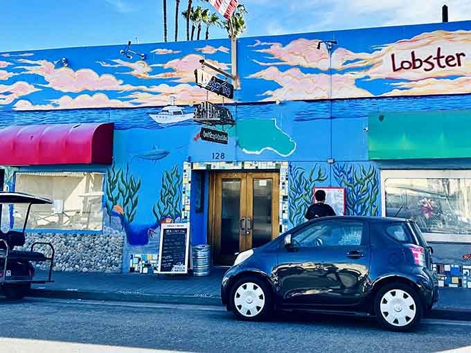 The Lobster Trap's vibrant mural announces fresh seafood with the subtlety of a tropical vacation fever dream.