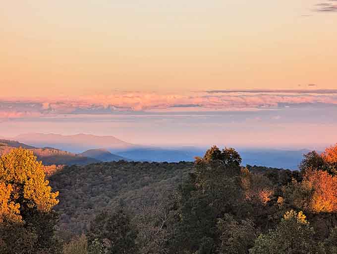 Sunset paints the mountains in shades of peach and lavender that seem almost too perfect to be real.