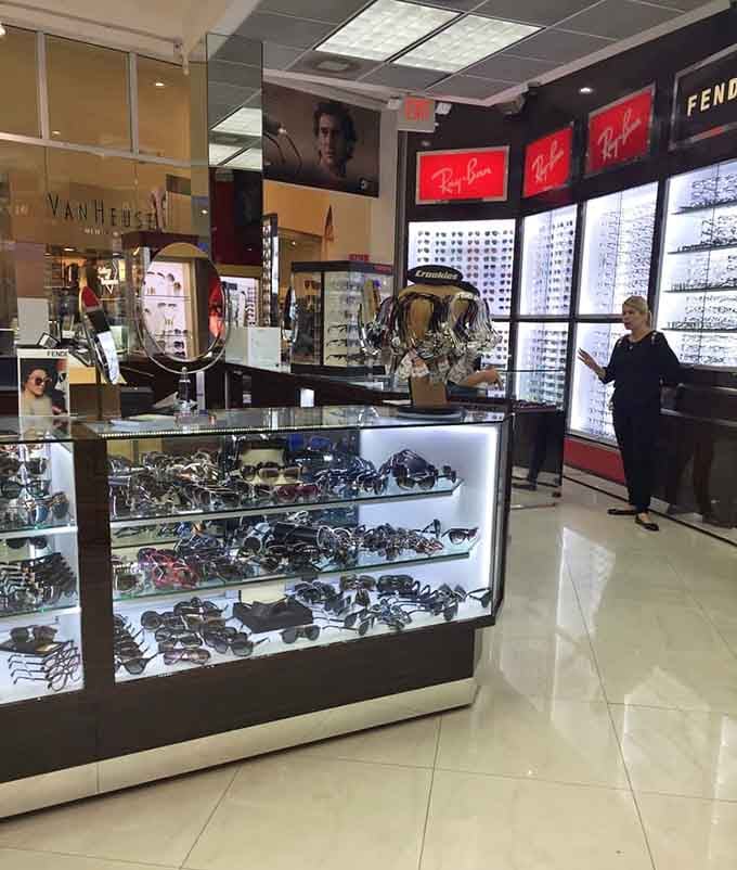 Designer eyewear gleams under perfect lighting, where Ray-Ban and Fendi promise to make you look mysteriously sophisticated instantly.