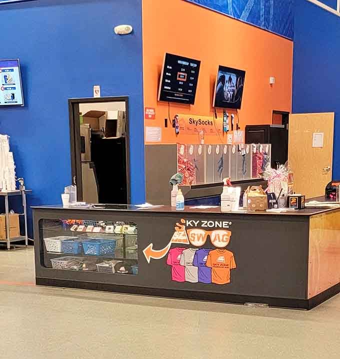 The admission desk where reasonable adults transform into giddy kids faster than you can say grip socks.