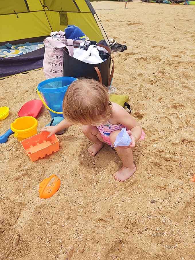 Little hands build sandy dreams while parents actually relax, the ultimate vacation achievement for families.