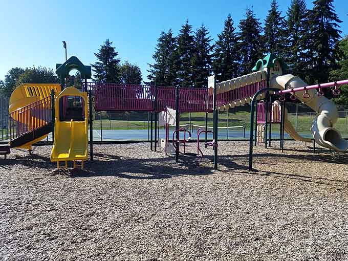 Colorful playground equipment promises hours of entertainment for grandkids while parents browse those endless antique shops nearby.