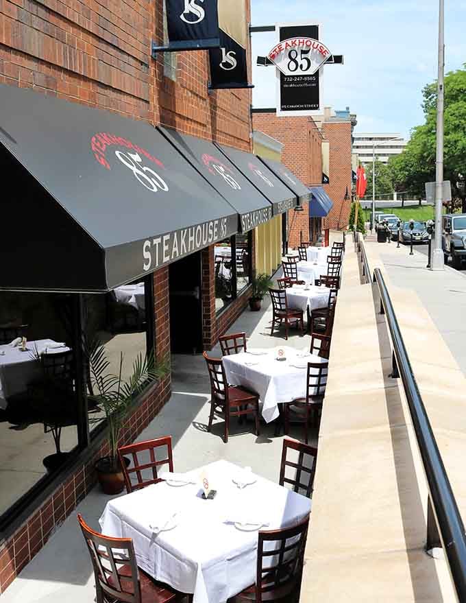 Outdoor sidewalk seating under black awnings lets you enjoy your steak while watching New Brunswick's vibrant street life unfold naturally.