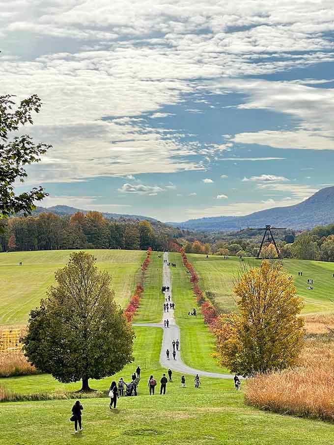 The path stretches endlessly forward, lined with trees and promises of more artistic discoveries ahead.