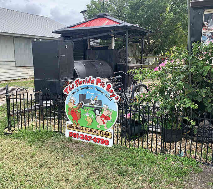 The cheerful signage and custom smoker setup that's become a beloved landmark for local barbecue enthusiasts.