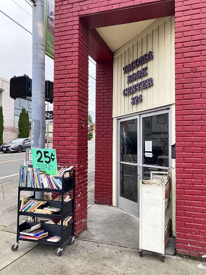 The unassuming entrance where literary adventures begin, complete with bargain books greeting you before you even step inside.