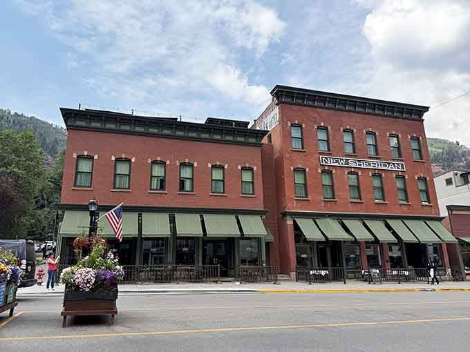 New Sheridan Hotel's green awnings shade sidewalks where history and hospitality have mingled for generations.