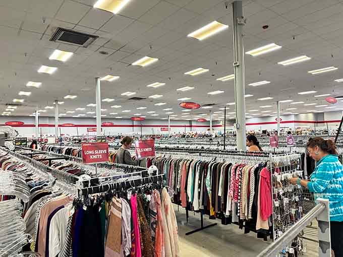 Fellow shoppers browse the endless racks, each on their own personal treasure hunt through secondhand paradise.