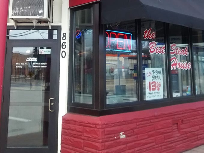 Those neon signs glowing in the evening promise warm hospitality and hot meals waiting just beyond the door.