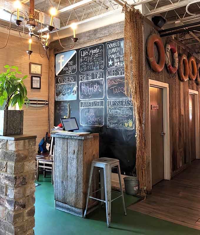 The hostess stand welcomes you with chalkboard specials and rustic charm that sets the tone for everything ahead.