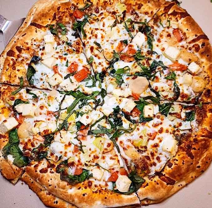 Wait, they serve pizza too? This flatbread masterpiece shows The Buff's talents extend beyond the breakfast menu.