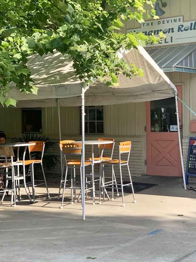 Shaded outdoor tables under mature trees offer the perfect spot for enjoying breakfast while watching the neighborhood come alive.