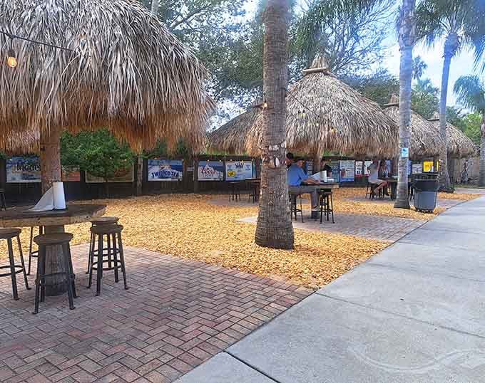 Tiki huts and high-top tables under swaying palms create the perfect outdoor dining room with nature's best air conditioning.