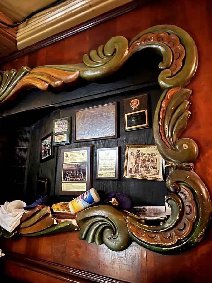 Elaborate woodwork framing decades of history, awards, and memories that make this place genuinely irreplaceable.