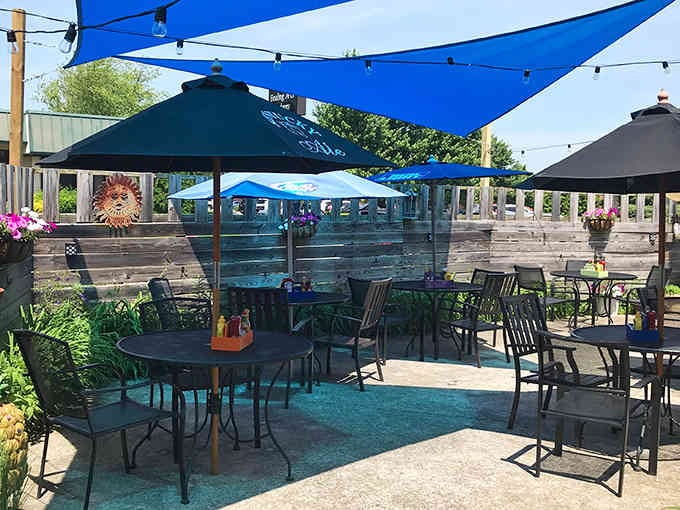 Outdoor seating under blue umbrellas transforms lunch into a mini vacation without leaving Lexington city limits.