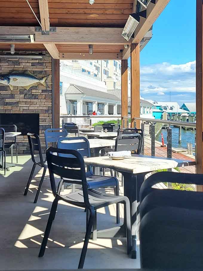 Outdoor patio seating with marina views and blue skies overhead, where every meal feels like a mini vacation from reality.