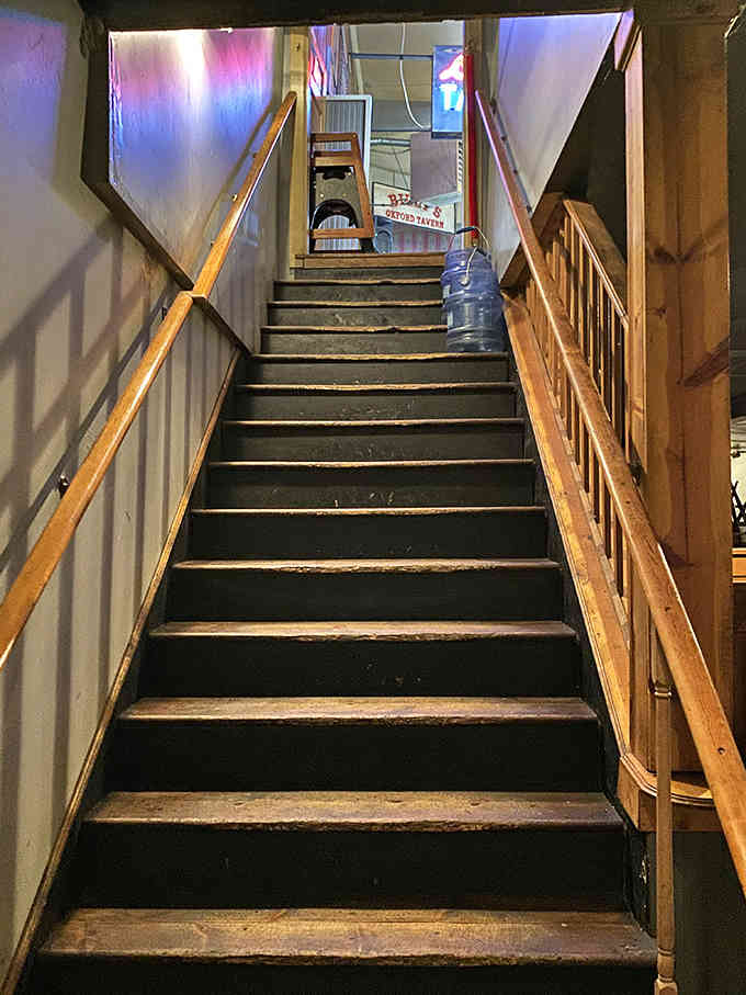 These well-worn stairs lead to more dining and entertainment spaces, each step creaking with character and countless footsteps.