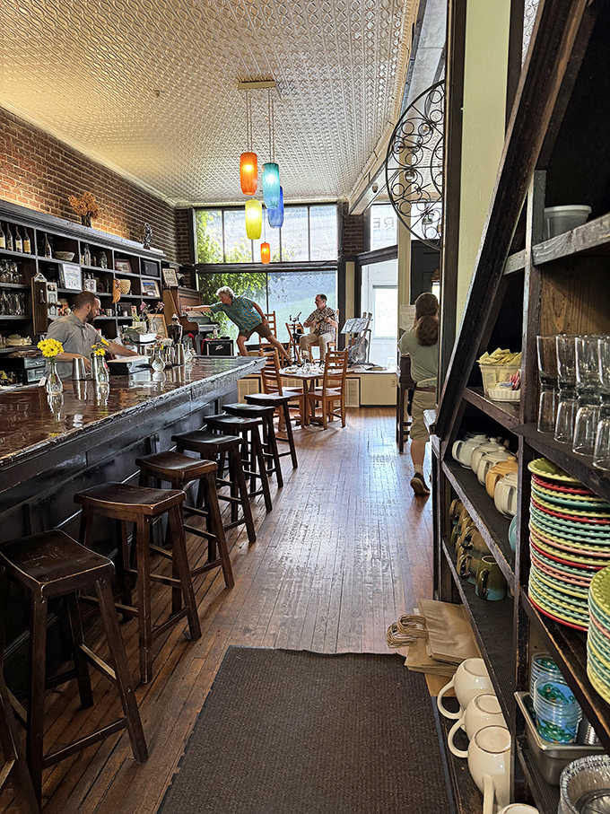 The bar area stretches invitingly along exposed brick, offering front-row seats to watch the culinary magic happen in real time.