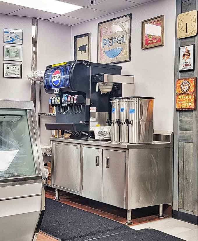 The beverage station surrounded by vintage signs, keeping things refreshingly simple while the meat does the talking.