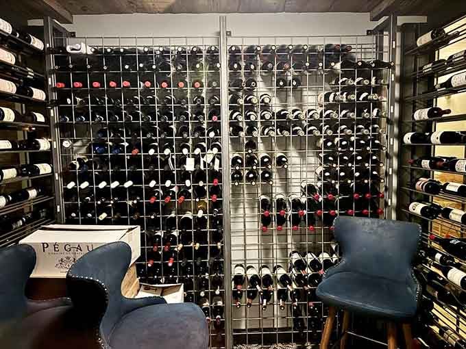 A glass-enclosed wine room displays bottles like liquid treasures waiting to enhance your perfect meal.