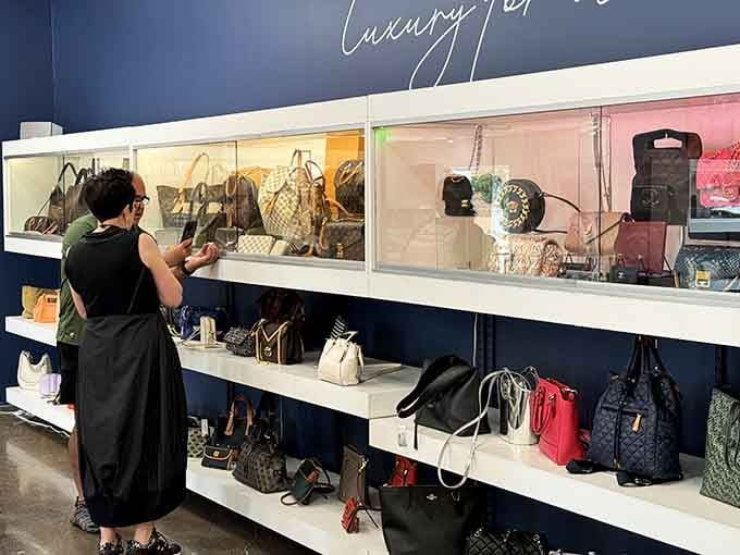 She's contemplating that wall of luxury handbags like an art collector at Christie's, because smart shopping requires careful consideration and excellent taste.